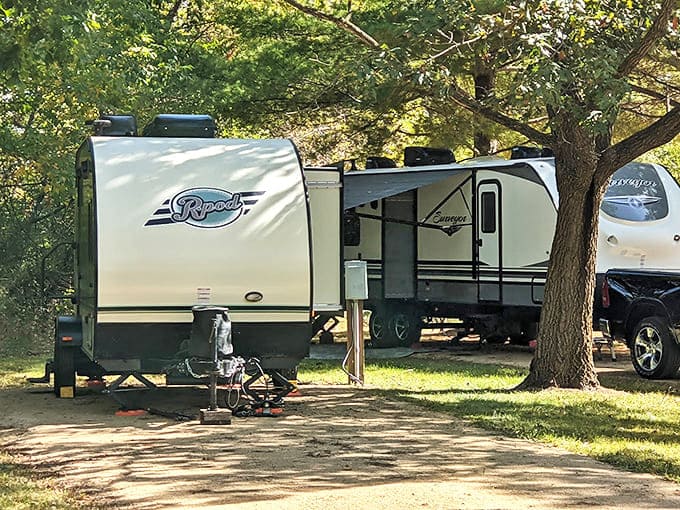 Home sweet temporary home! RVs nestle under shade trees, offering that perfect balance of wilderness adventure with just enough creature comforts.