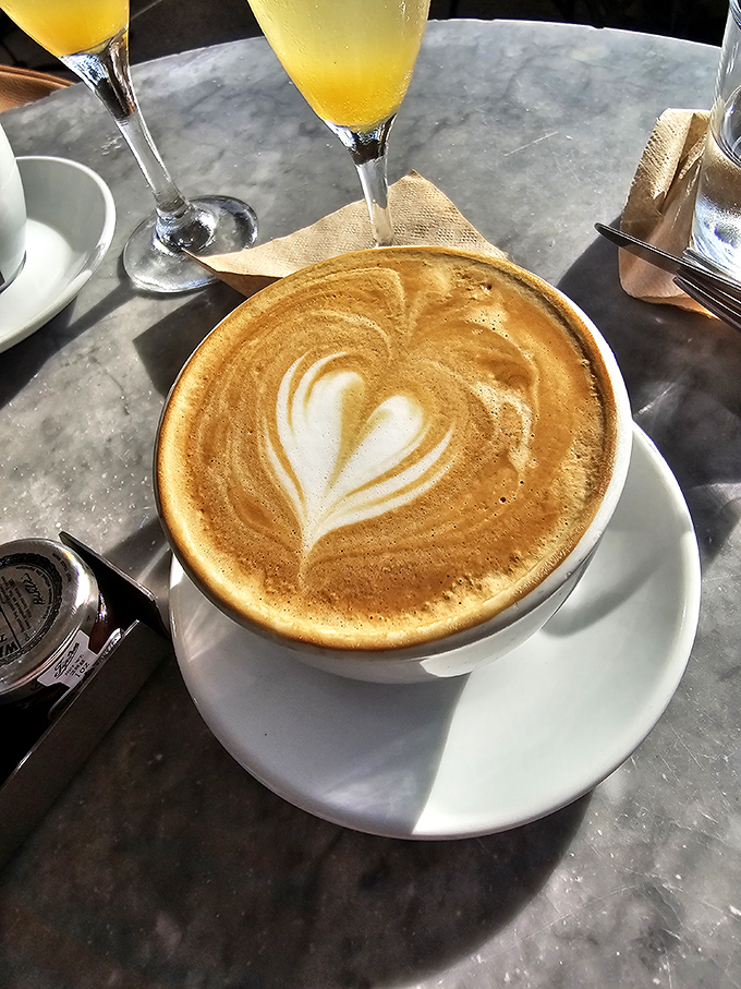 The cappuccino arrives with a heart-shaped foam confession – this isn't just coffee, it's liquid motivation to face the day with Miami-sized enthusiasm.
