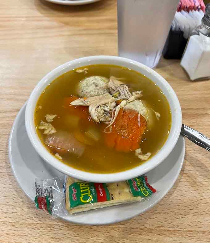 That matzo ball soup isn't just food, it's therapy in a bowl, complete with tender chicken and perfectly cooked vegetables.