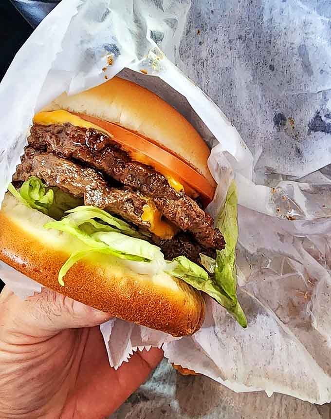 The platonic ideal of a cheeseburger &ndash; fresh lettuce, melty American cheese, and a perfectly seasoned patty on a soft bun.