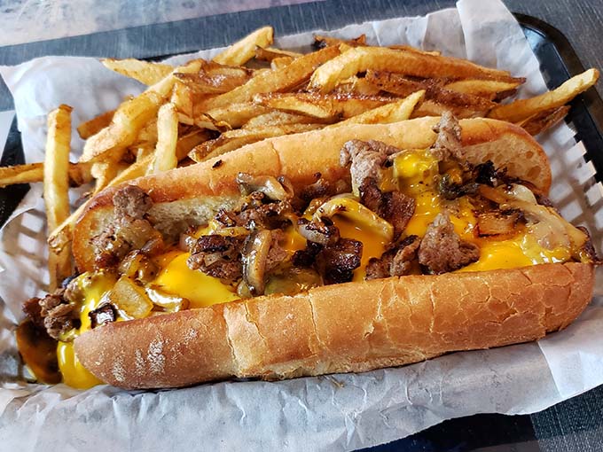 The Philly cheesesteak sandwich arrives overflowing with meat and melted cheese, demanding both your attention and extra napkins.
