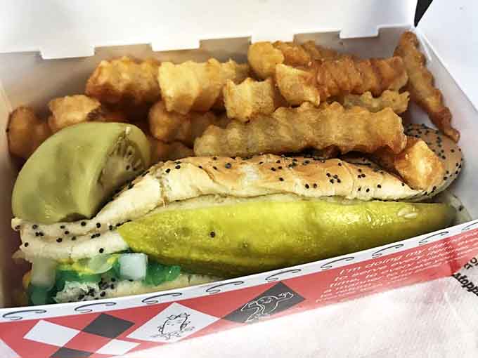 The complete Superdawg experience: a fully-dressed Chicago dog nestled alongside golden crinkle-cut fries and that signature pickle spear.