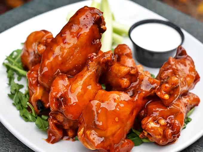 Wings that deserve their own fan club &ndash; plump, juicy, and glistening with house-made sauce that strikes the perfect balance between sweet and heat.