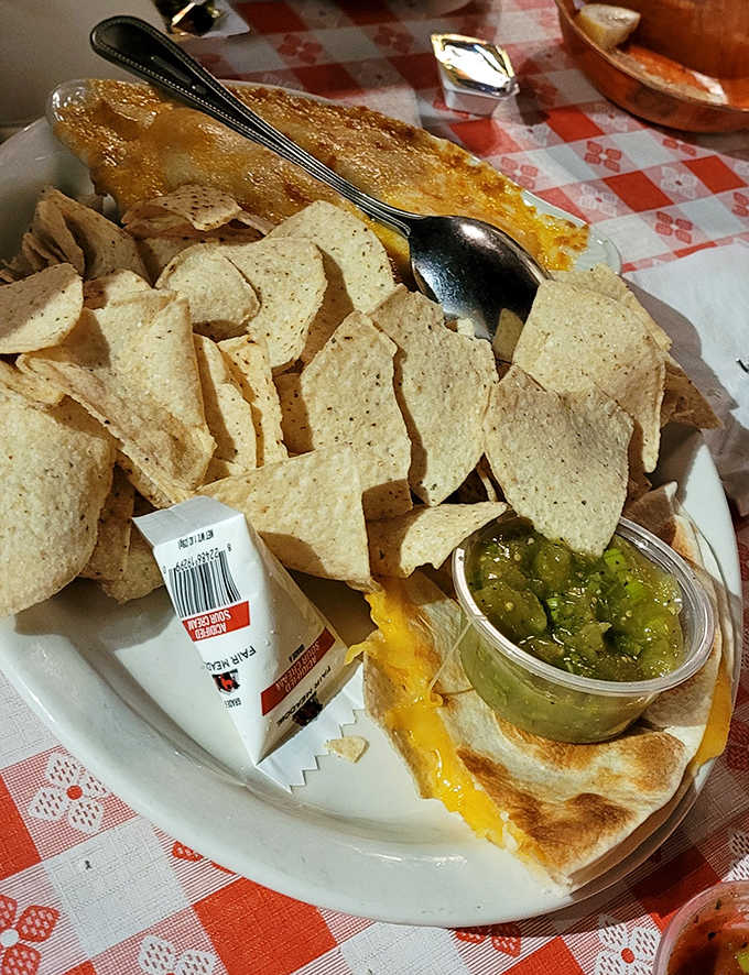 Melted cheese blankets homemade tortilla chips, with fresh salsa adding just enough kick to wake up your taste buds.