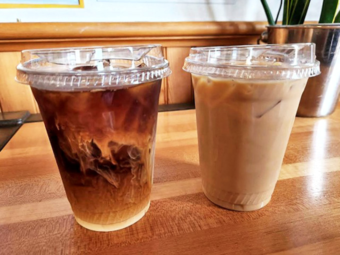 A study in contrasts &ndash; one dark and brooding, one light and sweet. Coffee's yin and yang presented in clear plastic cups.