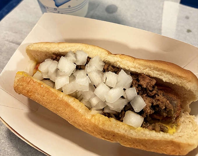 The classic Coney dog in all its glory &ndash; a perfect harmony of savory meat sauce, diced onions, and yellow mustard that creates flavor fireworks with every bite.