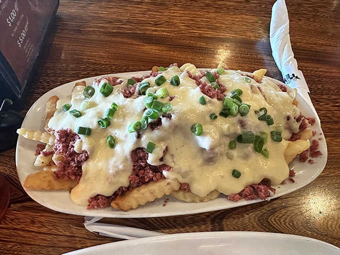 Crinkle fries smothered in savory gravy and cheese &ndash; comfort food that hugs your soul while challenging your belt.