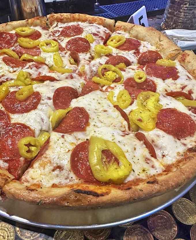 The classic cheese pizza showcases what makes Leaderboard special &ndash; perfect crust architecture supporting rivers of mozzarella beneath bright, herb-flecked sauce.