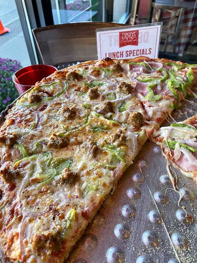 Sausage, onions, and green peppers create the holy trinity of pizza toppings, proving that sometimes the classics become classics for very good reasons.