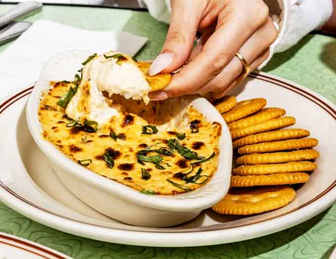 Melted cheese, crispy edges, and savory toppings create a dish that's both comfort food and culinary adventure on a single plate.