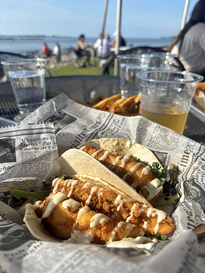 Crispy fish tacos drizzled with creamy sauce and served with a crucial squeeze of lemon &ndash; portable ocean flavor in every bite.