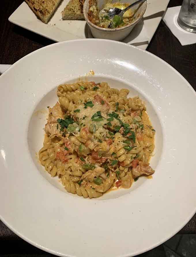 Golden pasta spirals catch every drop of that luscious sauce, proving that sometimes the simple things in life are the best things.