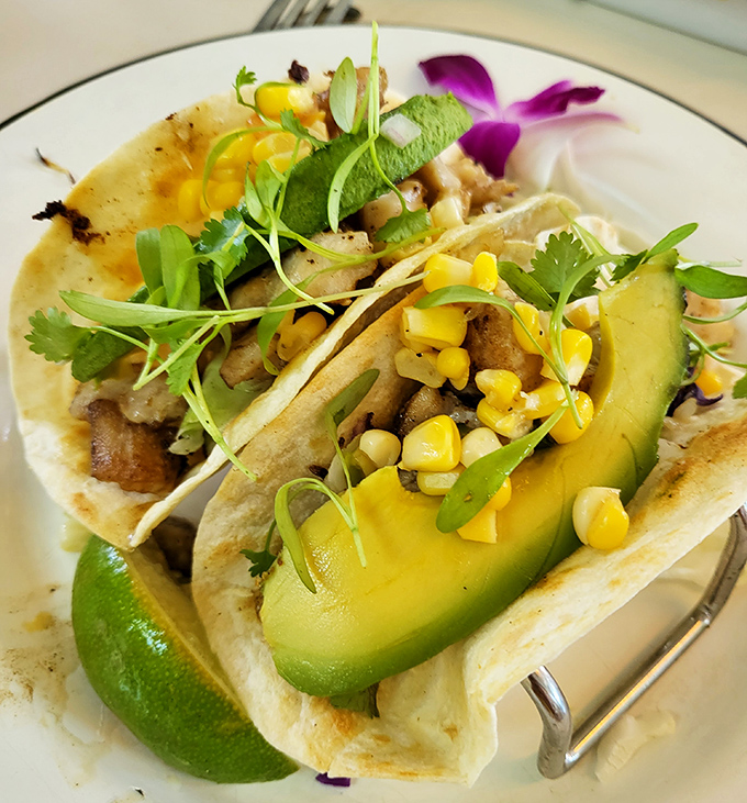 These tacos aren't just food, they're edible art – avocado slices, sweet corn, and fresh herbs create a colorful fiesta on your plate.