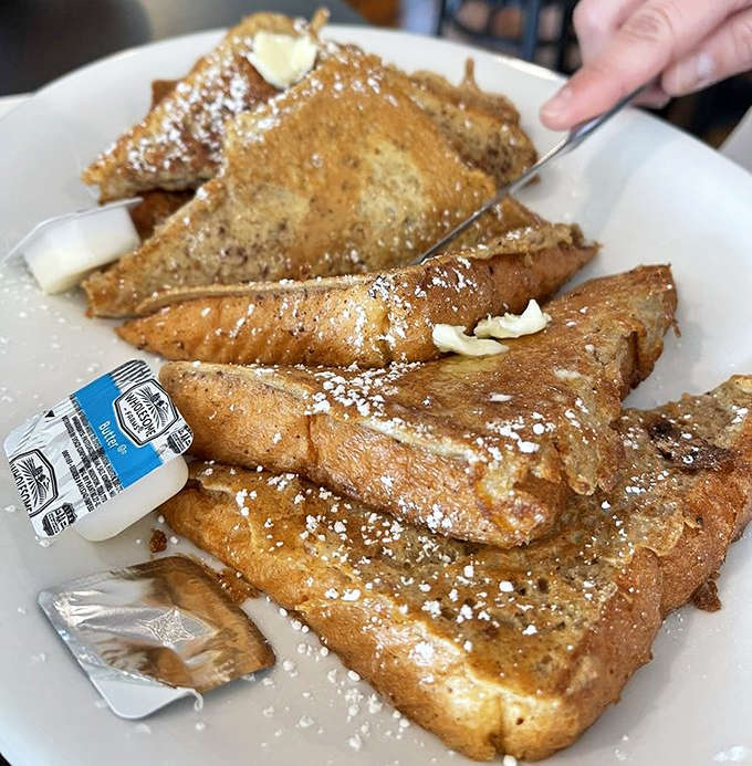 French toast that belongs in the Breakfast Hall of Fame &ndash; golden-brown perfection swimming in strawberry sauce with a cloud of whipped cream.
