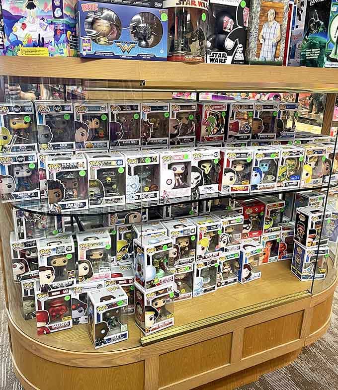 Funko Pop figures stand guard in their boxes, their oversized heads nodding to pop culture from Batman to Beyonc&eacute;.