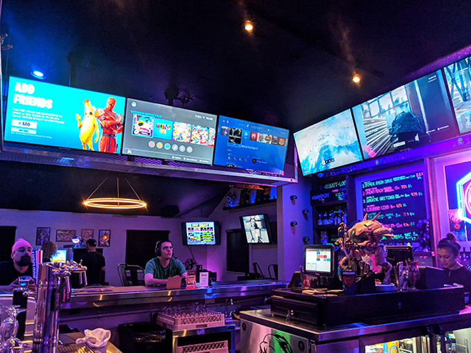The bar's screens showcase everything from live sports to classic gaming footage, creating a backdrop for conversations between button-mashing sessions.