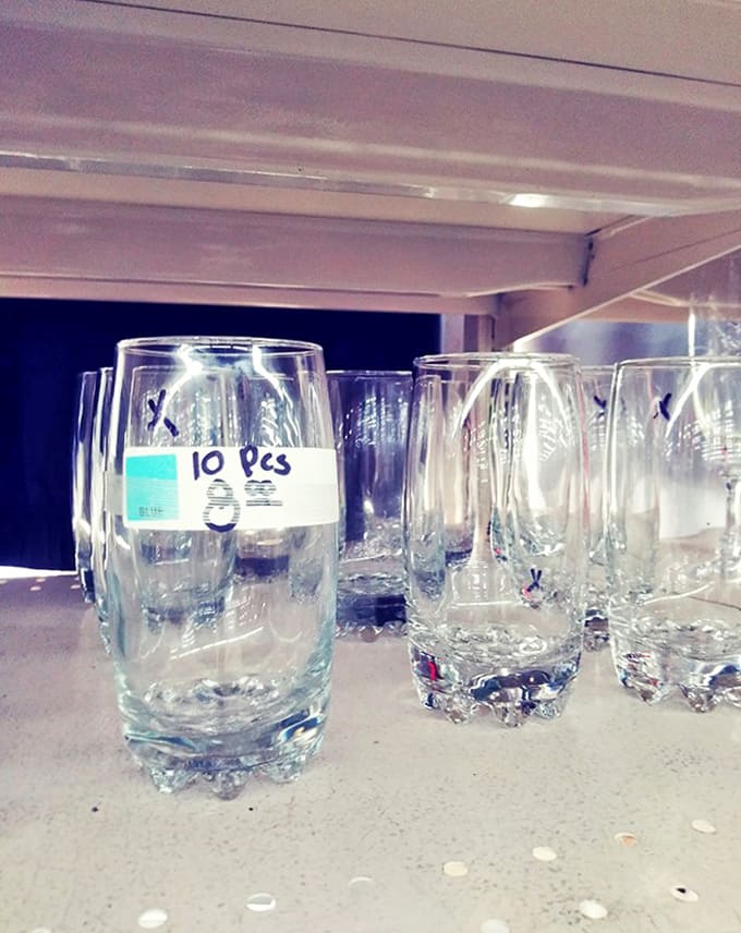 Crystal catches light while everyday tumblers stand at attention. These shelves hold drinking vessels from elegant soir&eacute;es to backyard barbecues of decades past.