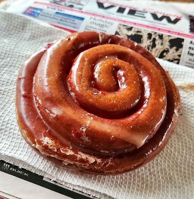 The cinnamon roll that launched a thousand cravings &ndash; spiral perfection with a glaze that catches the morning light like edible stained glass.