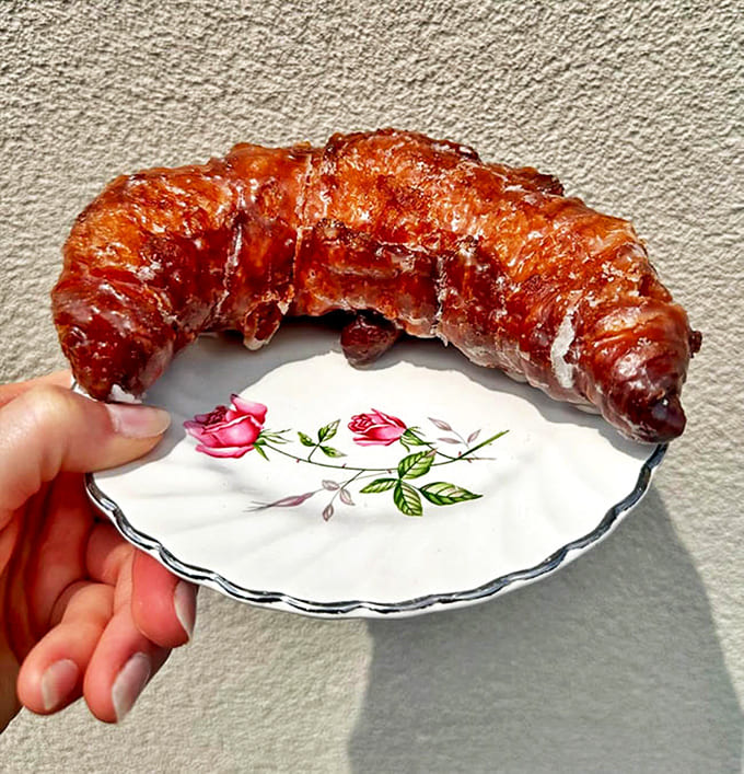 This isn't just any croissant &ndash; it's a glistening, caramelized work of art that shatters into buttery shards with each heavenly bite.