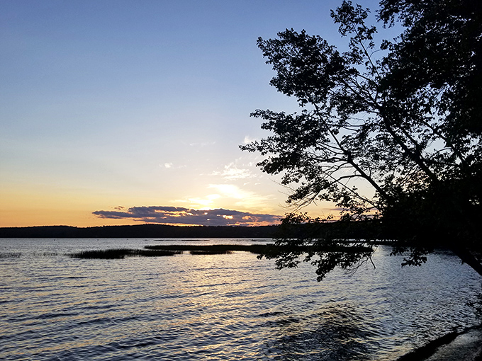 That magical moment when day surrenders to dusk, casting a golden spell across the tranquil waters.