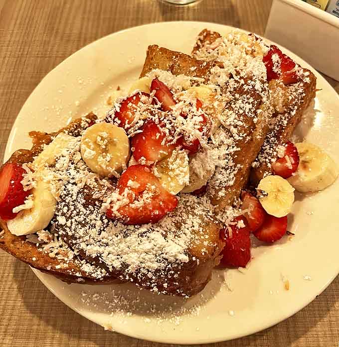 French toast so thick and perfectly grilled it makes regular bread jealous, topped with enough fruit to technically count as healthy.