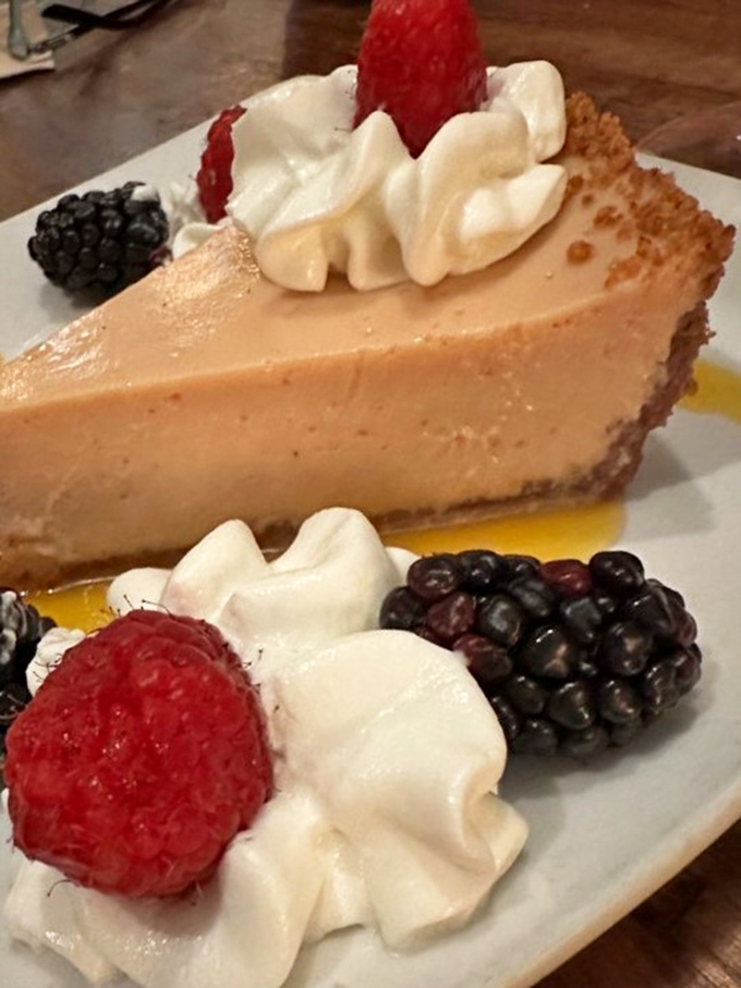 Fresh berries and whipped cream crown the famous Guava Lime Pie, adding bursts of color and texture to this Florida dessert revelation.