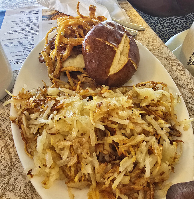 This pretzel bun burger with hash browns isn't just lunch – it's a masterclass in comfort food engineering.