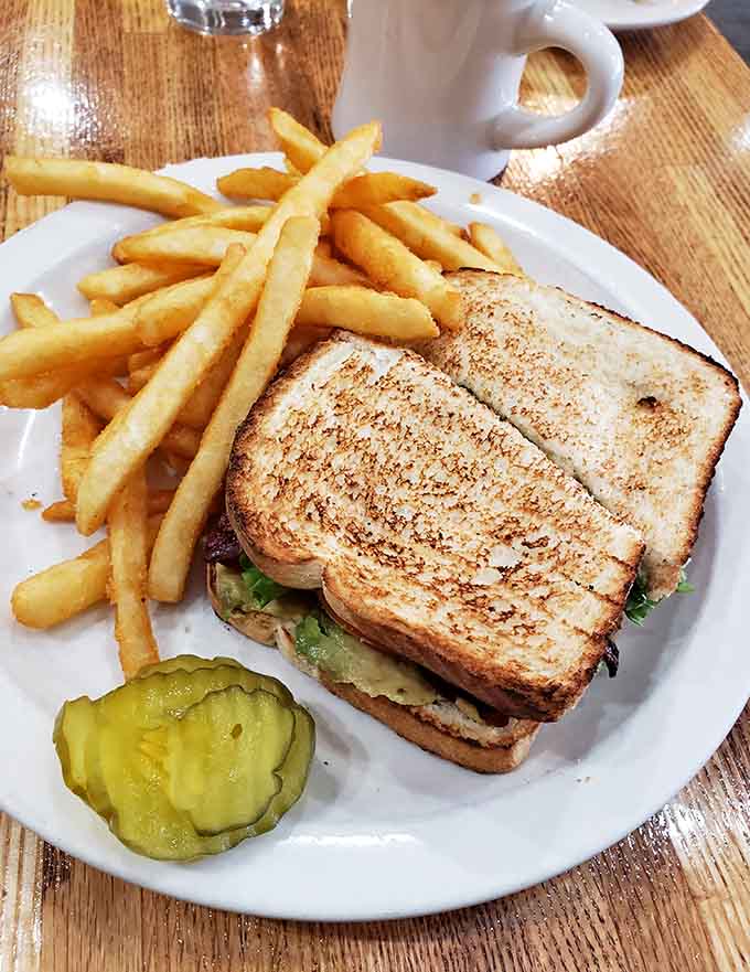 A BLT with golden fries proves this cafe handles lunch as capably as breakfast, because good cooking transcends meal categories.