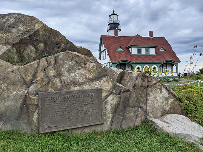 A weathered plaque commemorates the lighthouse's storied past, etched into stone much like the landmark itself is etched into America's maritime history.