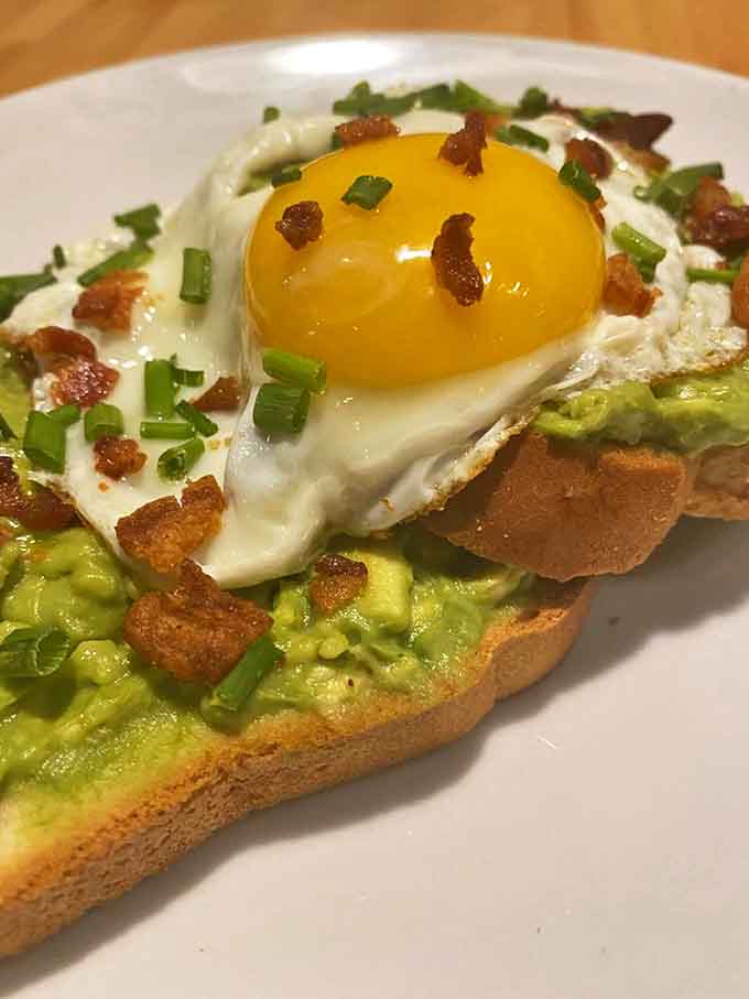 Gluten-free avocado toast topped with a perfectly runny egg proves that dietary restrictions don't mean sacrificing flavor or Instagram-worthy presentation.