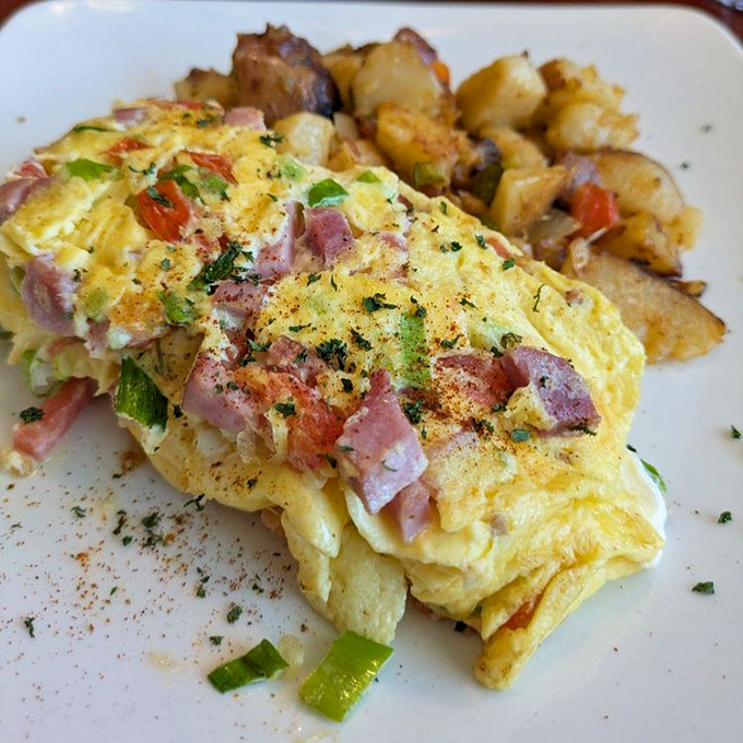The House Special omelet arrives like a colorful patchwork quilt of ham, peppers, and cheese&mdash;comfort food elevated to art form.