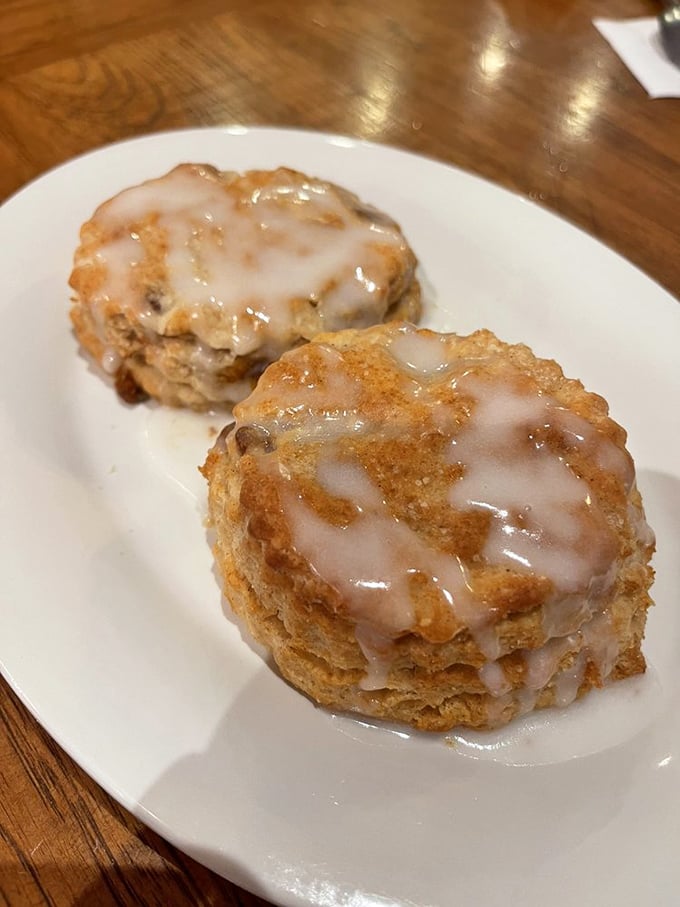 Two golden-brown biscuits basking in the glow of morning light, their icing slowly melting like snowcaps on a warm spring day.