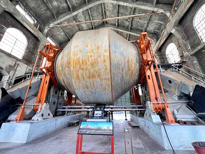 Inside Quincy Mine: The massive hoist wheel rests in industrial grandeur, a mechanical heart that once pulsed with the rhythm of mining life.