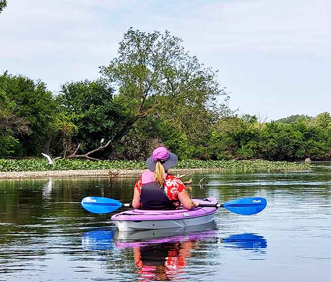 Paddling through paradise, where each stroke reveals another shade of blue in waters so clear they seem almost apologetic about their transparency.
