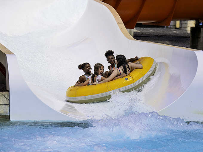 Pure joy captured in motion &ndash; these kids riding the yellow tube are experiencing what summer memories are made of.