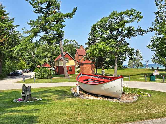 A bright red lifeboat rests on the manicured grounds, telling silent stories of rescue missions and the lighthouse's role in protecting those who braved Lake Huron's temperamental moods.