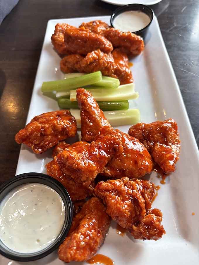 Buffalo wings done right, with that perfect coating and the celery sticks standing by for support.