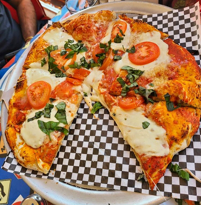 Fresh basil and tomato slices elevate this margherita pizza from simple to sublime &ndash; proof that quality ingredients need little embellishment.