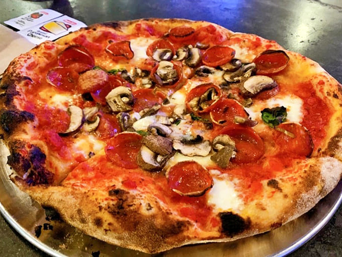 A perfect threesome &ndash; pepperoni, mushrooms, and melted cheese &ndash; having a hot date on a perfectly charred crust.