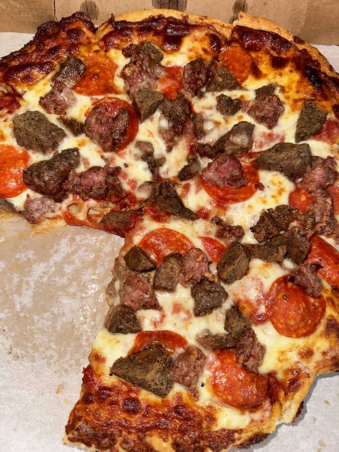 The meat lover's pizza doesn't just have toppings &ndash; it's practically a carnivore's dream landscape with pepperoni pools.