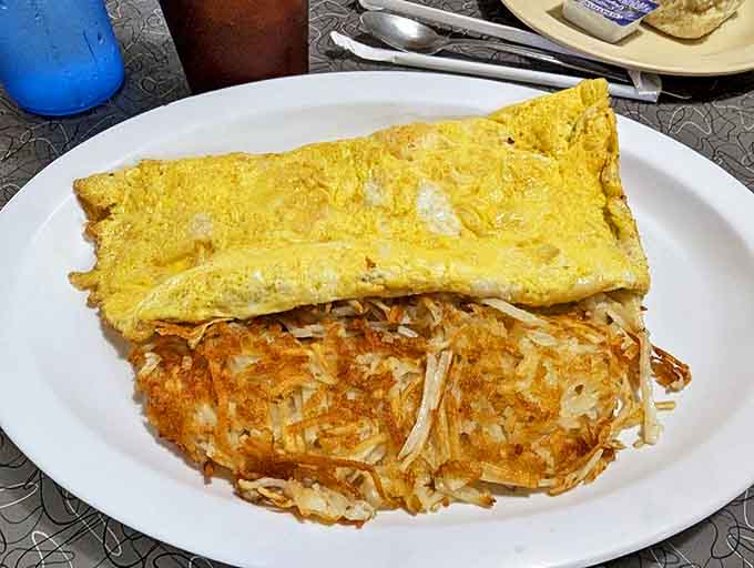 This cheese omelet paired with golden hash browns represents everything right about diner breakfast, generous portions and honest cooking combined.