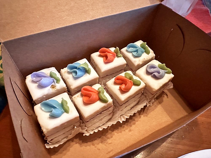 Tiny frosting flowers bloom atop these petite squares of joy, proof that sometimes the best things come in small, edible packages.
