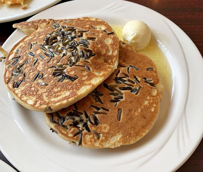Wild rice pancakes bring Minnesota flavor to the table, adding nutty complexity that transforms familiar breakfast into something uniquely regional and delicious.