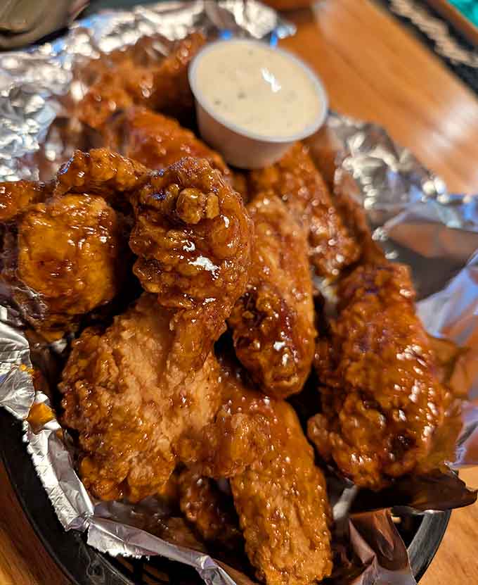 These beautifully sauced buffalo wings in their foil-lined basket are what dreams are made of, seriously.