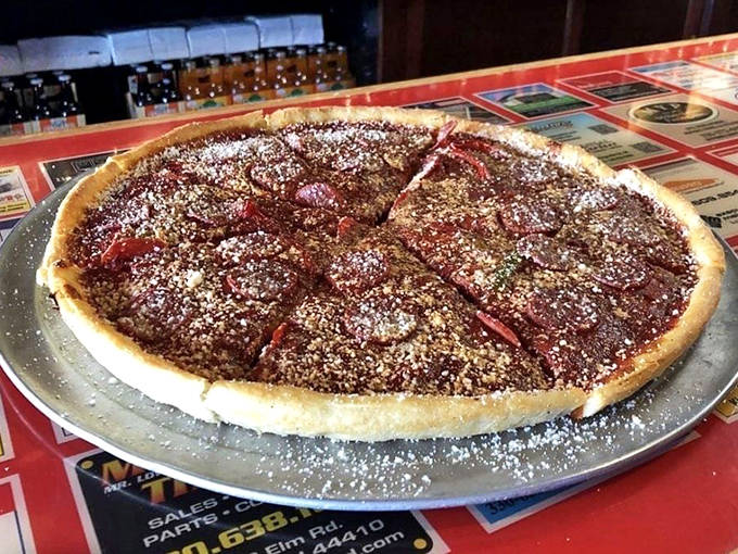 The Old World pizza arrives dusted with powdered sugar, a sweet finale that challenges everything you thought you knew about dessert pizzas.