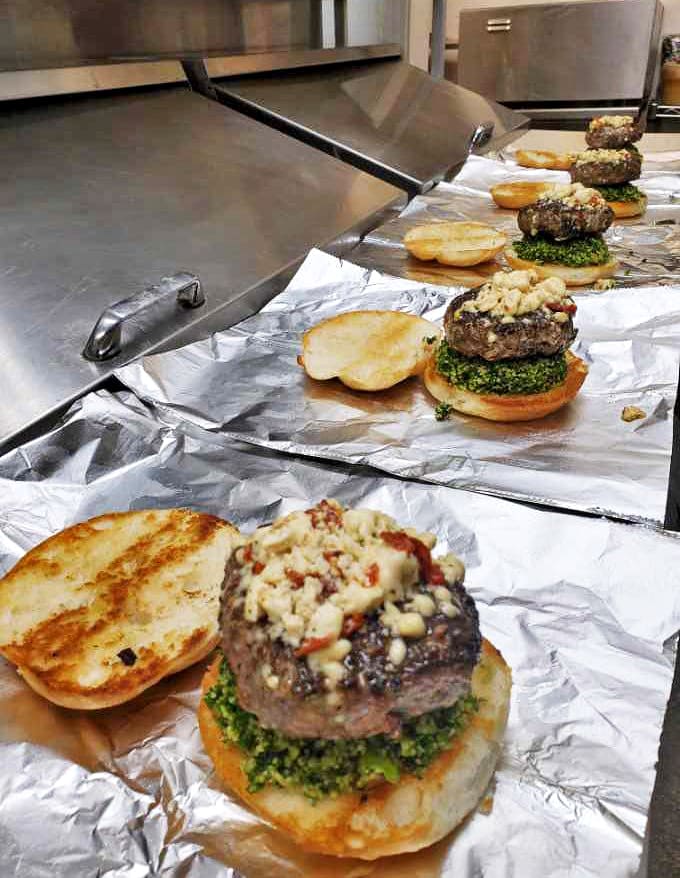 Behind-the-scenes glimpse of burger artistry in progress &ndash; each one awaiting its destiny to become someone's new obsession.
