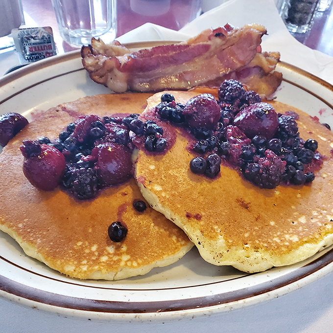 Berry-studded pancakes that make you question why you'd ever order anything else &ndash; Vermont maple syrup not optional but essential.