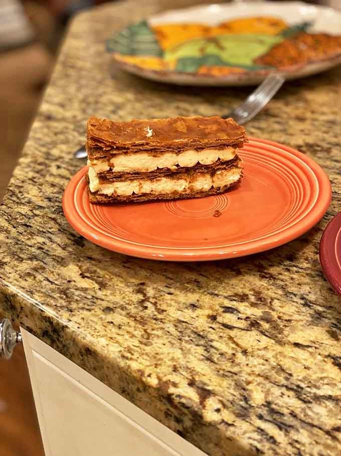 The mille-feuille showcases architectural precision with its impossibly thin layers of caramelized pastry and silky cream filling.