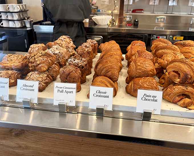 Rows of croissants and pastries lined up like delicious soldiers, each one a testament to hours of careful lamination and love.
