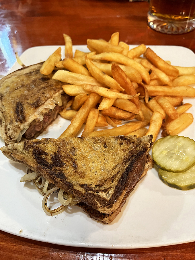 Golden-crisp fries flank a patty melt that's achieved legendary status among Route 66 travelers seeking authentic roadside cuisine.